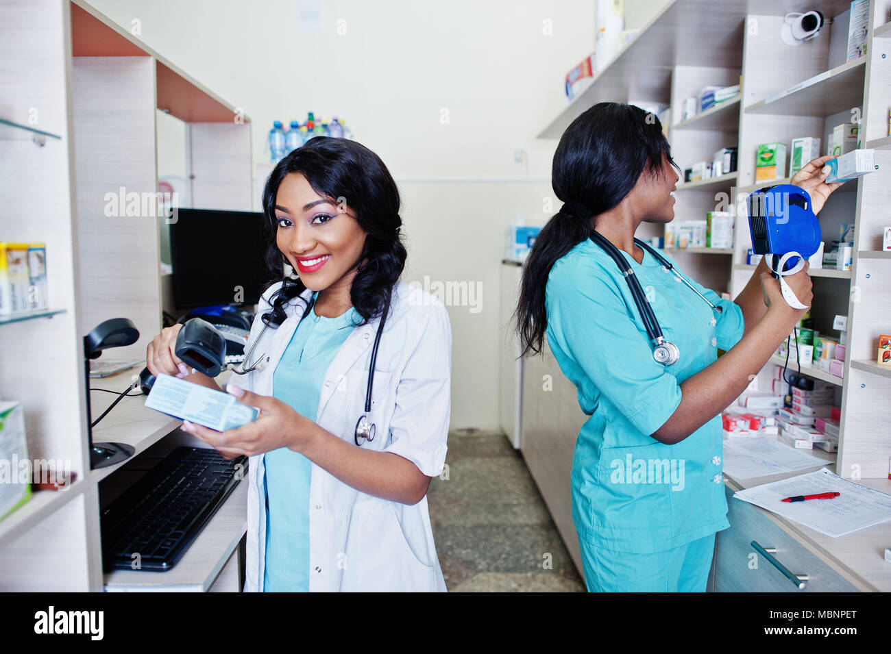 Two african american pharmacist working in drugstore at hospital ...