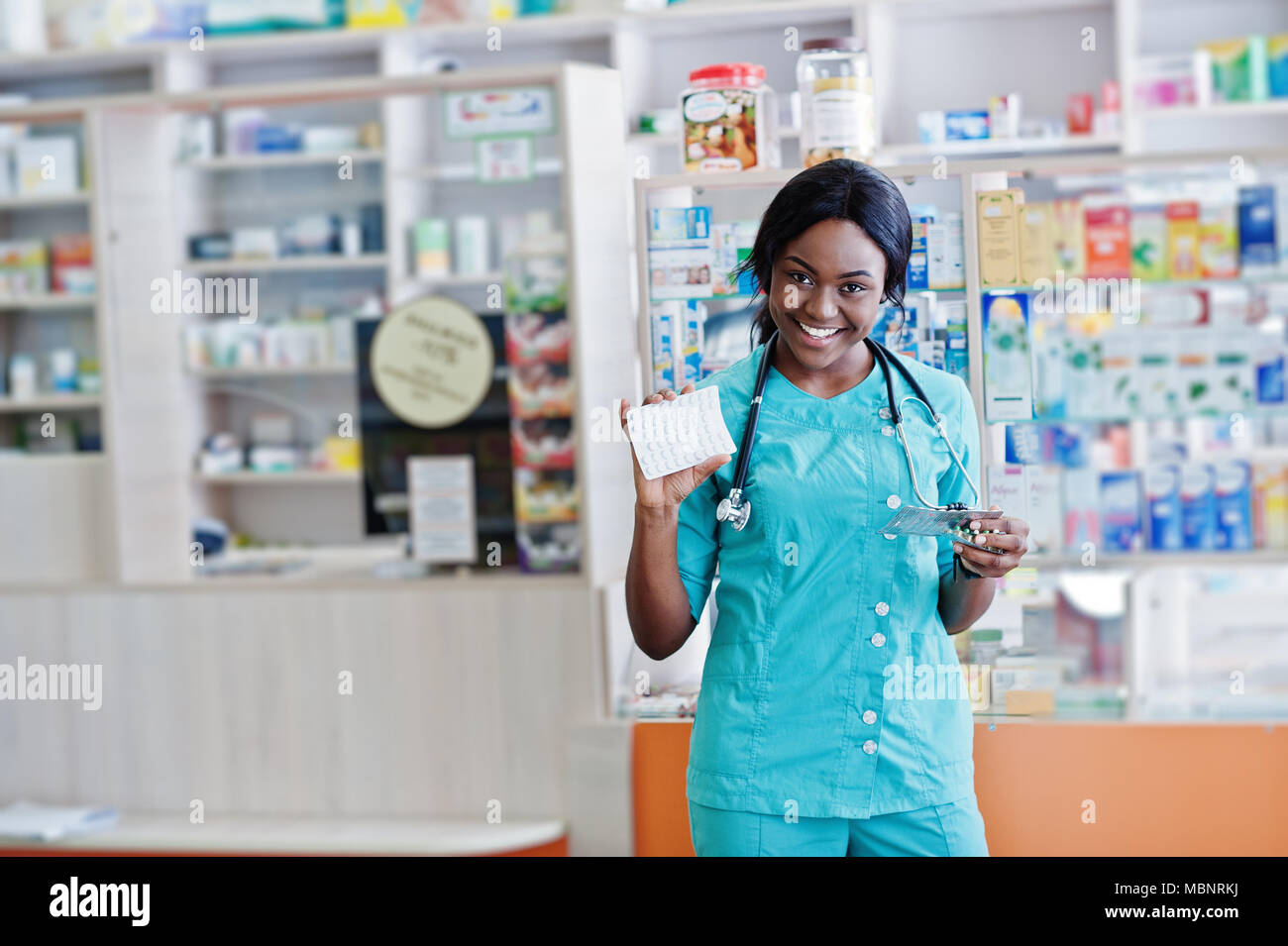 African american pharmacist working in drugstore at hospital pharmacy ...