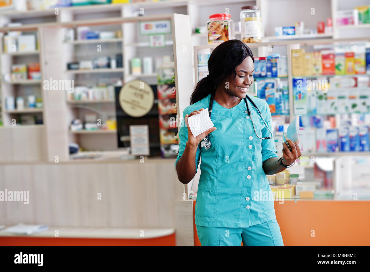 African american pharmacist working in drugstore at hospital pharmacy ...