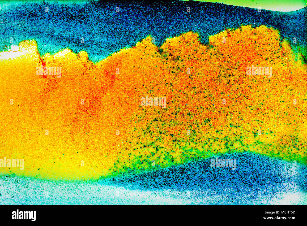 Colorful sand pigments falling down in water. Abstract landscape ...