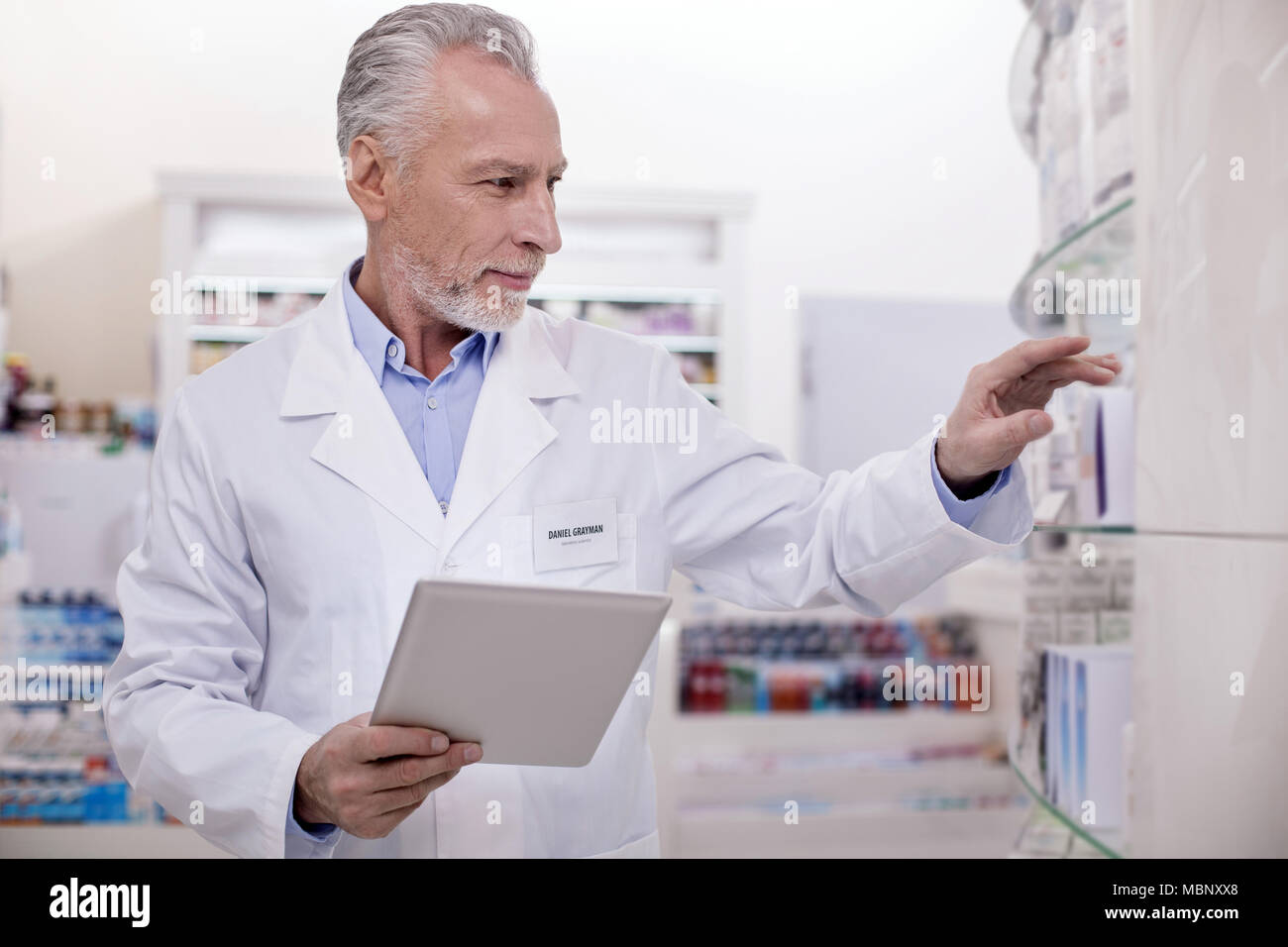 Meditative male pharmacist inputting data Stock Photo - Alamy