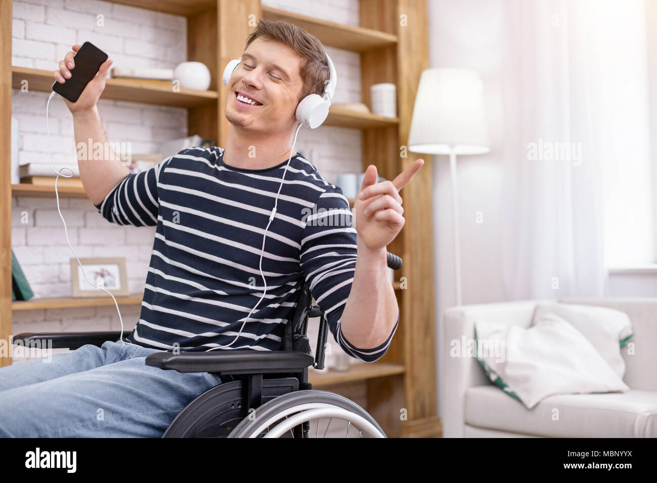 Attractive young man being pleased Stock Photo - Alamy