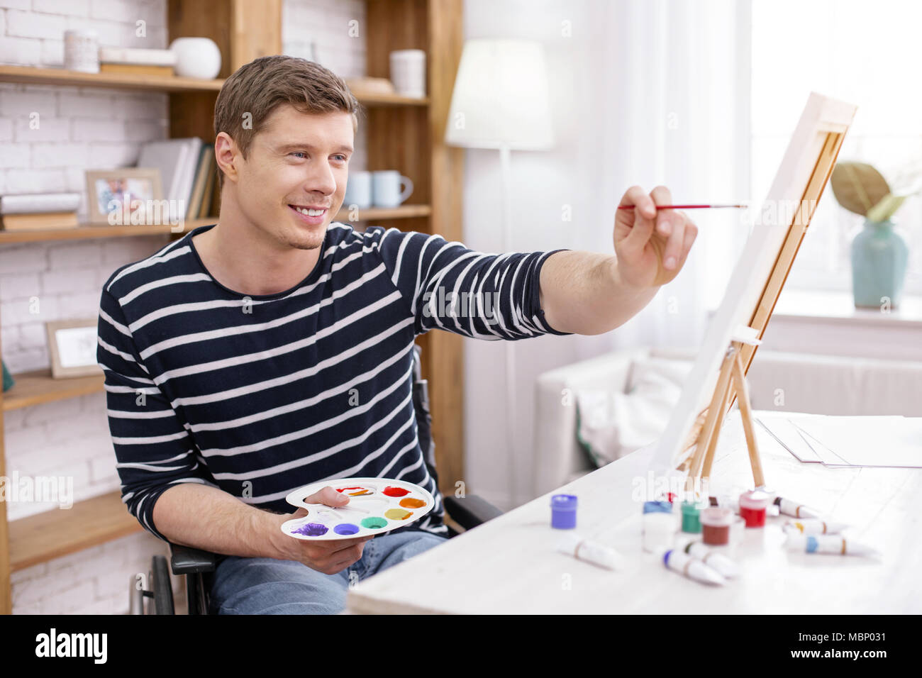 Attractive man painting on canvas hi-res stock photography and images ...