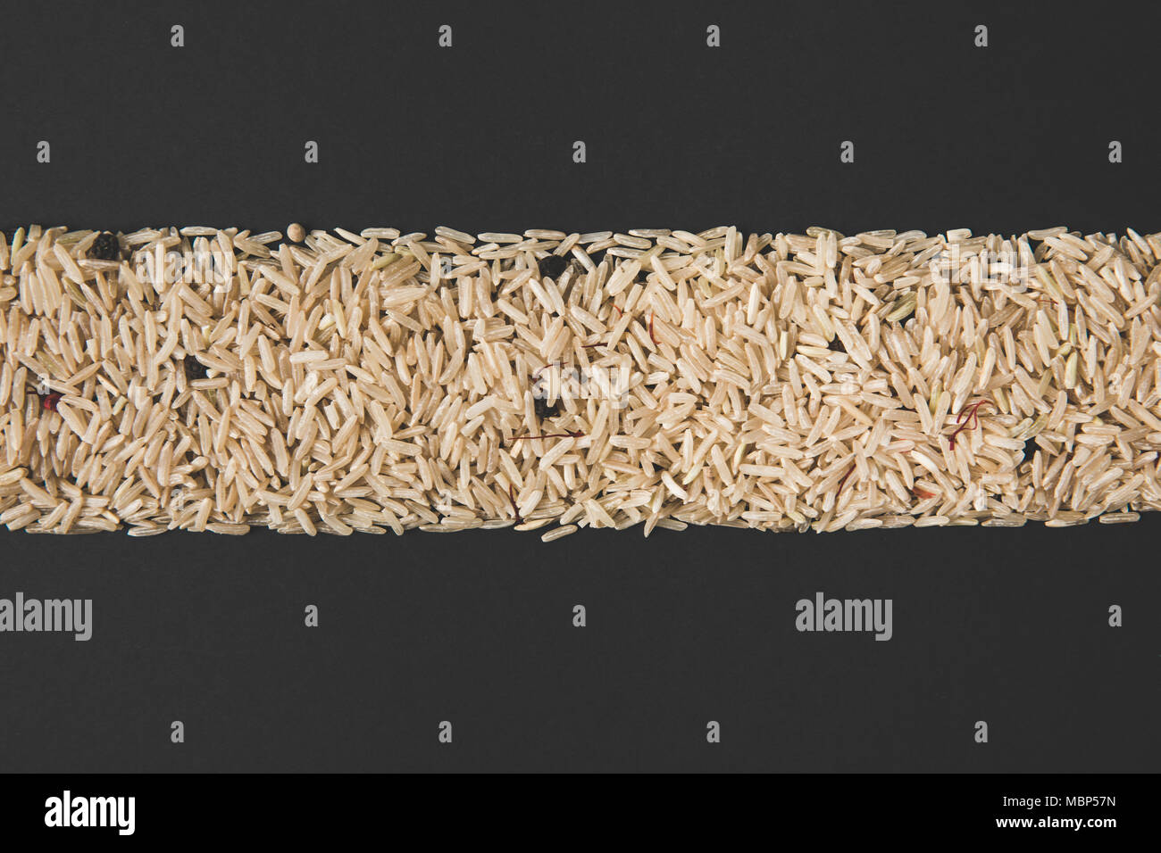 top view of stripe of raw rice isolated on black Stock Photo - Alamy