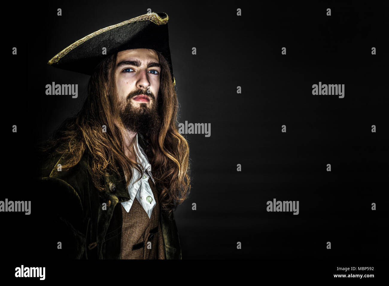 Portrait of a medieval bearded pirate on black background Stock Photo ...