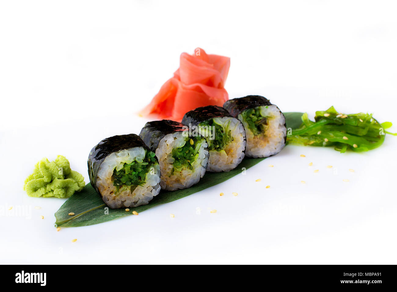 Delicious fresh mini-rolls with algae of Chukka on a banana leaf. Sushi ...