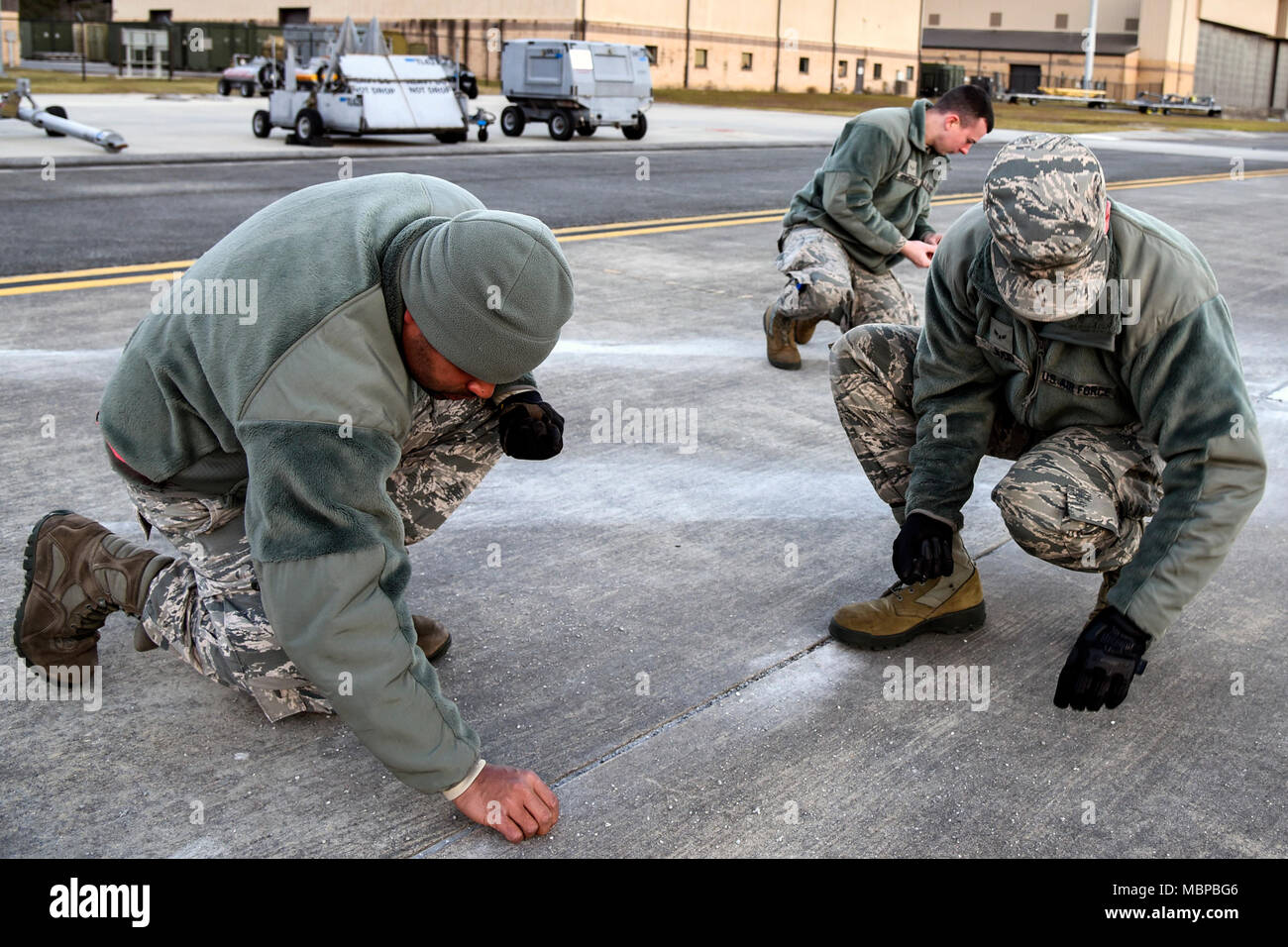 Team Moody Airmen grab debris off of the flight line during a foreign ...