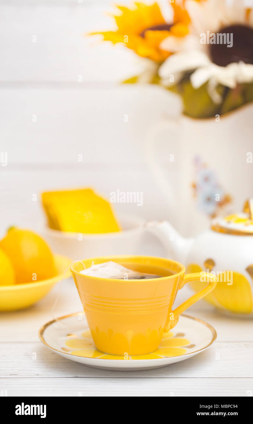 Bright Yellow Tea Set on a White Wood Table Stock Photo - Alamy