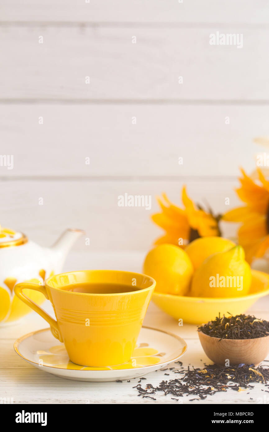 Bright Yellow Tea Set on a White Wood Table Stock Photo - Alamy