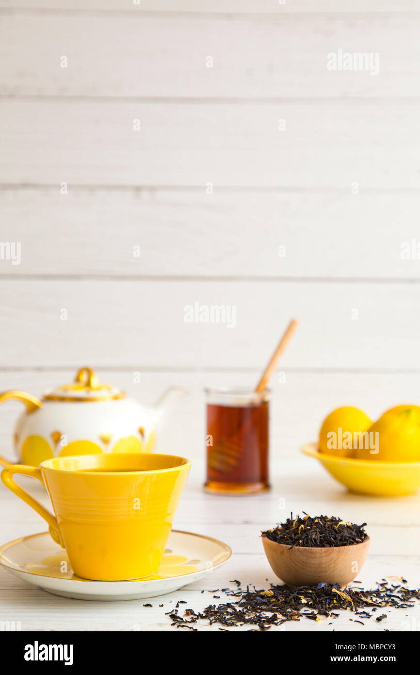 Bright Yellow Tea Set on a White Wood Table Stock Photo - Alamy
