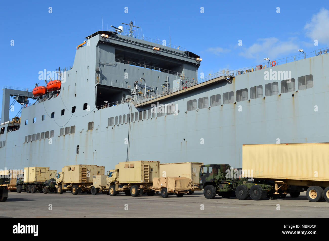 Vehicles assigned to the 25th Infantry Division, wait to be loaded ...