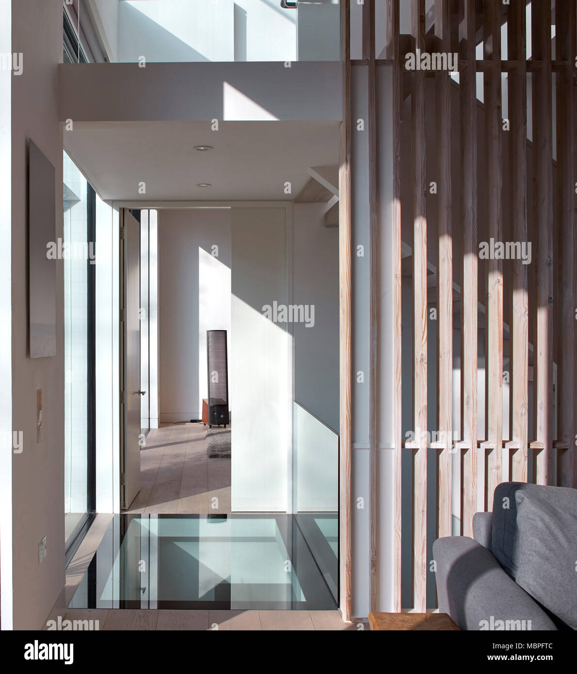 View into sunlit corridor with glazing. Highland House, Kent, United ...