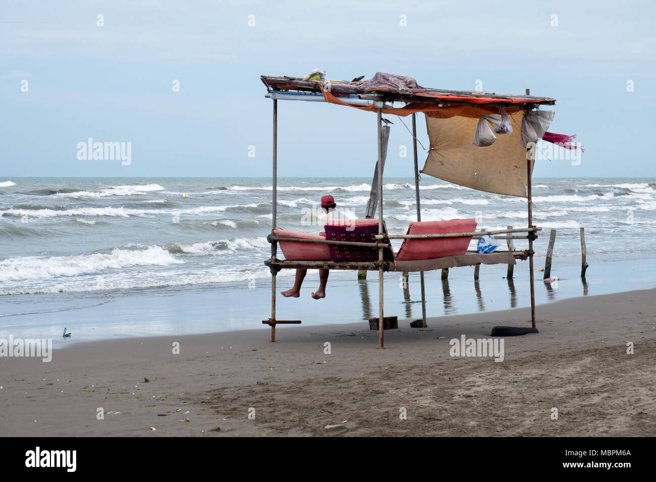 Man sitting on a traditional persian sea bench along the Caspian coast ...