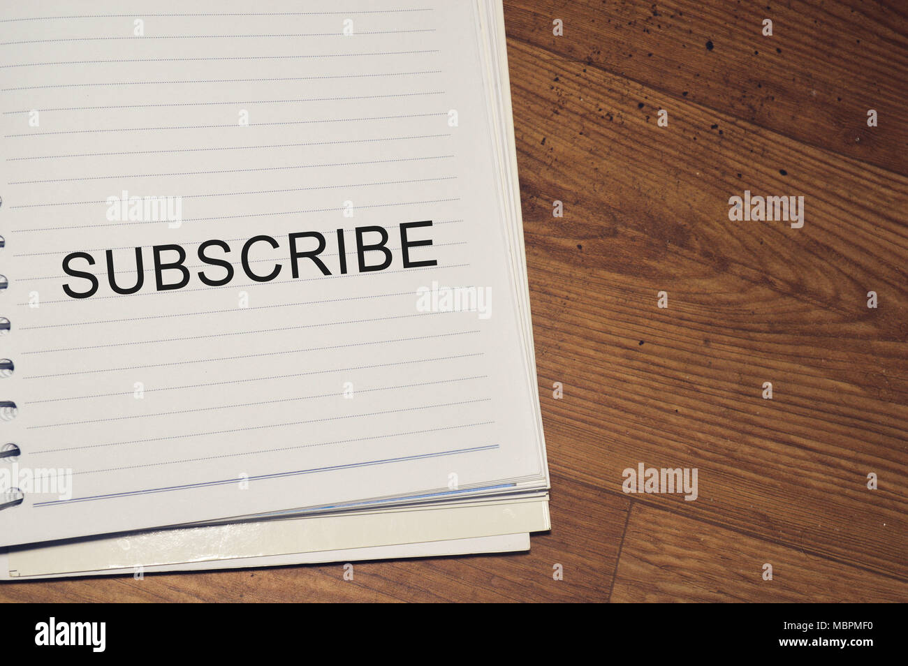 Subscribe word written on white paper Stock Photo - Alamy