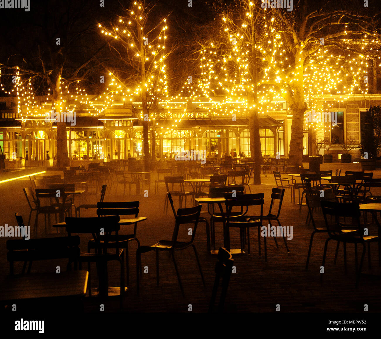 empty night restaurant, lot of tables and chairs with noone, magic ...