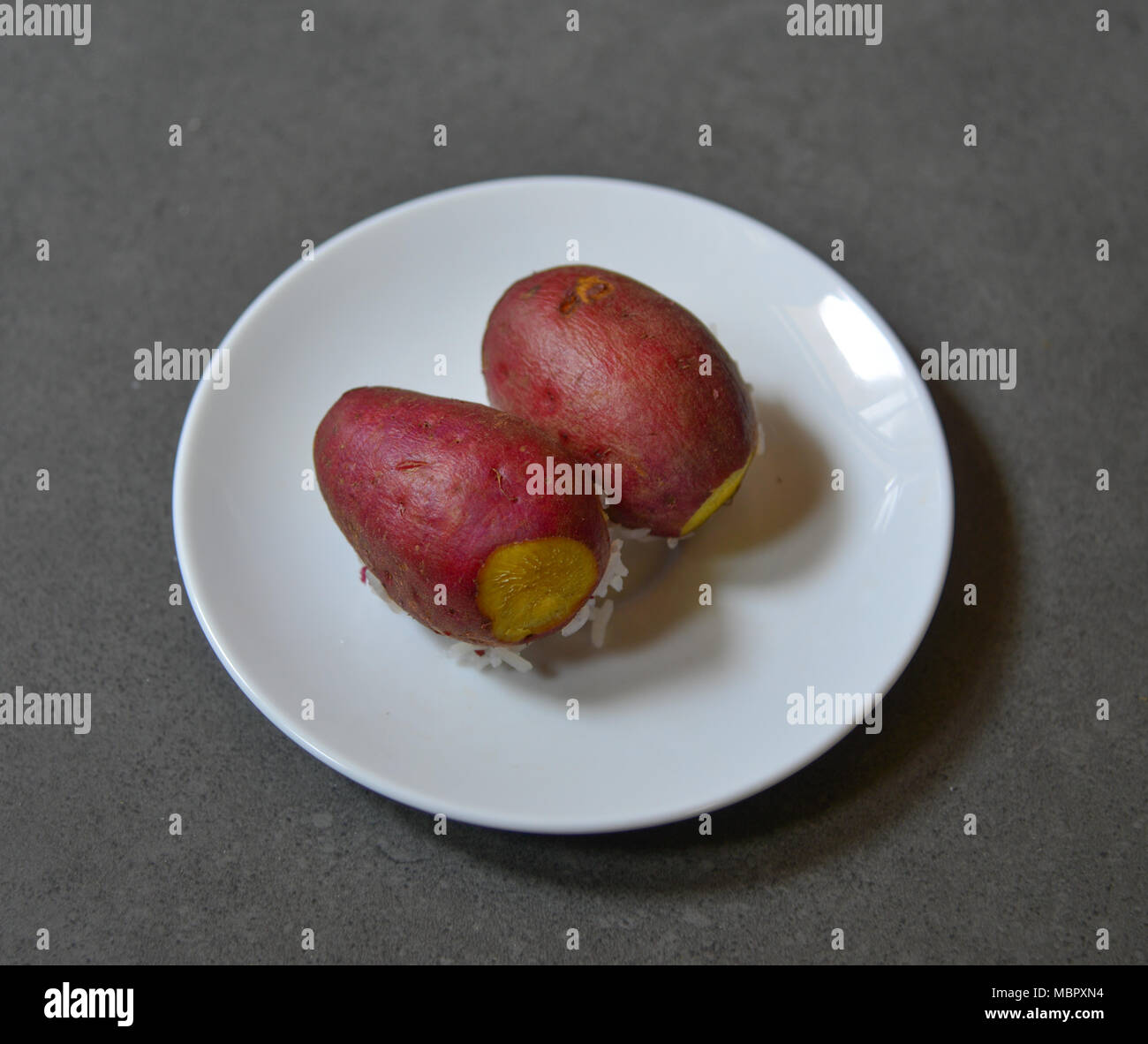 Sweet potatoes on white dish. Its large, starchy, sweet-tasting ...