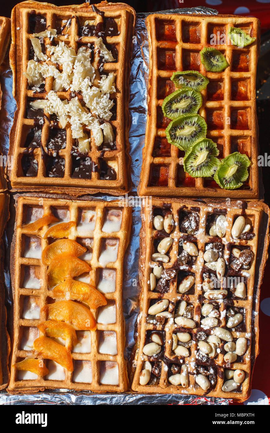 Homemade square belgian waffles with kiwi fruit and orange. Top view ...