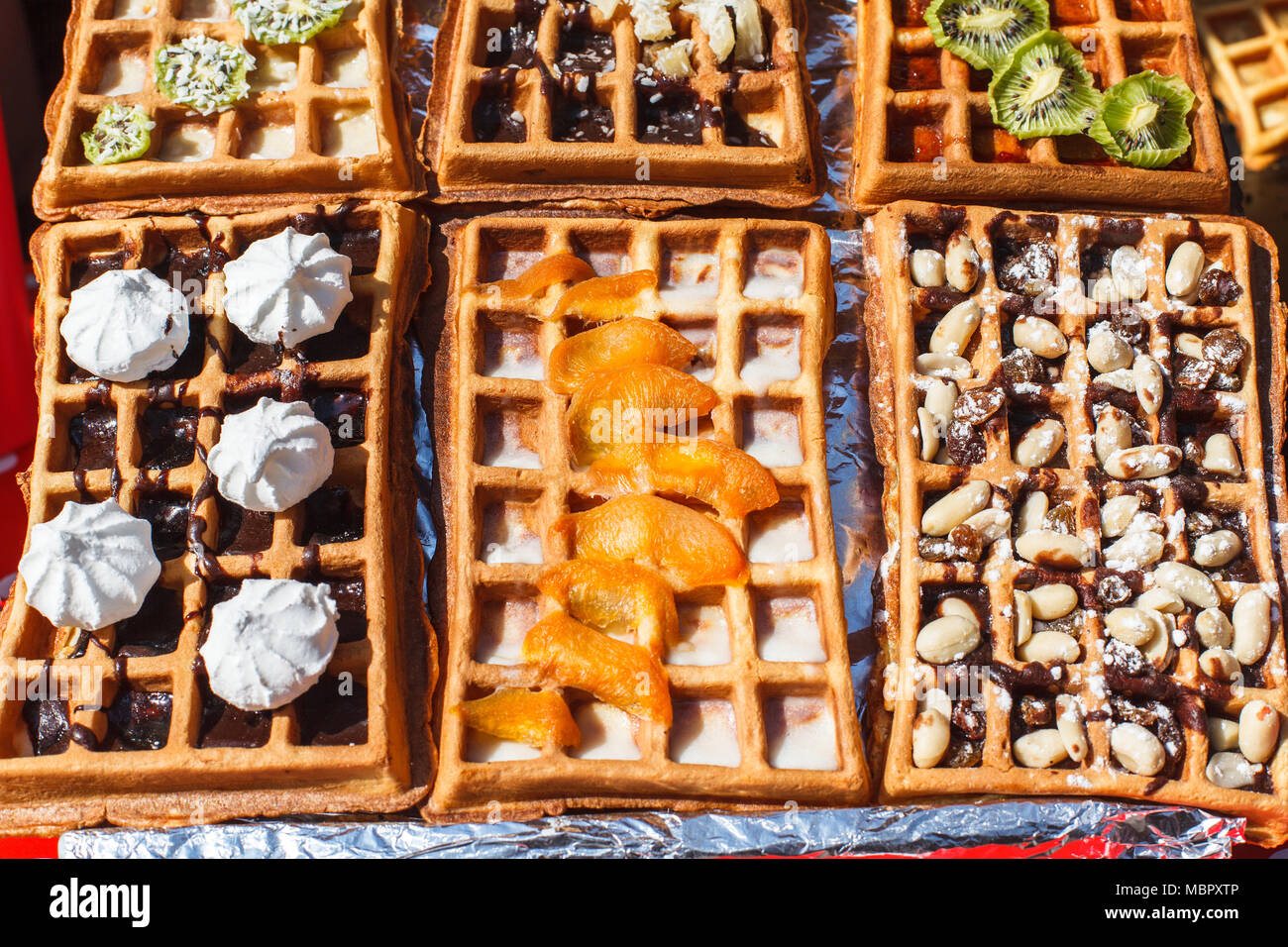 Homemade square belgian waffles with kiwi fruit and orange. Top view ...