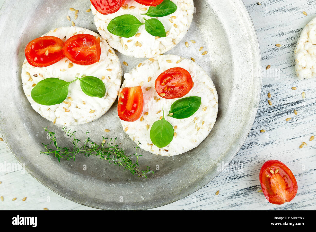 Healthy Rice Cakes with cherry tomatoes, cheese feta, basil and sesame ...