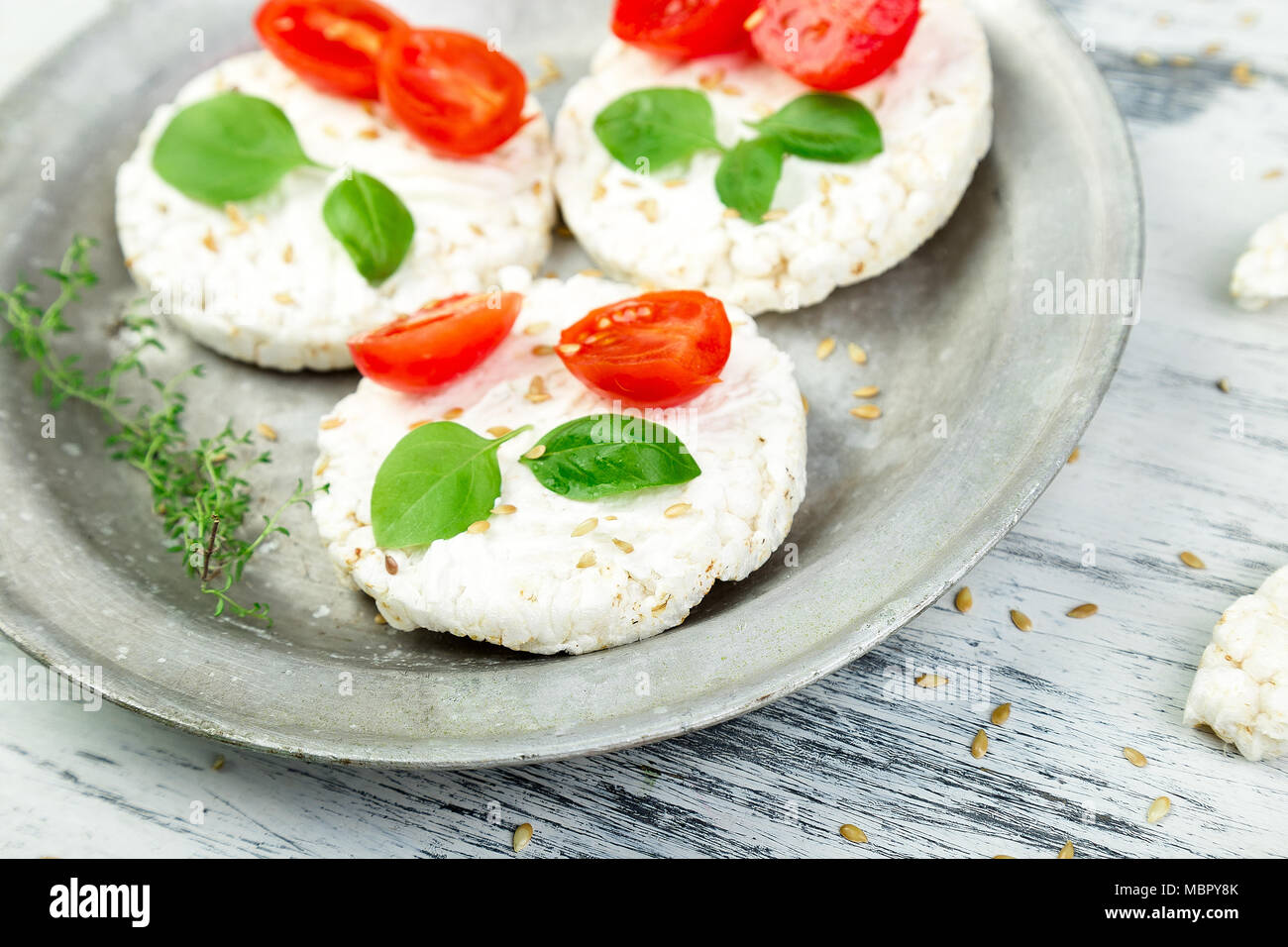 Healthy Rice Cakes with cherry tomatoes, cheese feta, basil and sesame ...