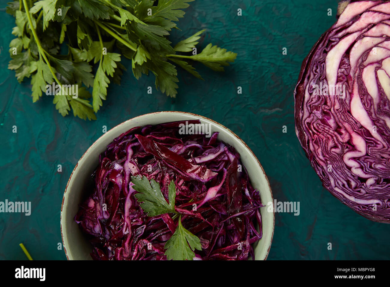 Shredded red cabbage in bowl on green background. Vegetarian healthy ...