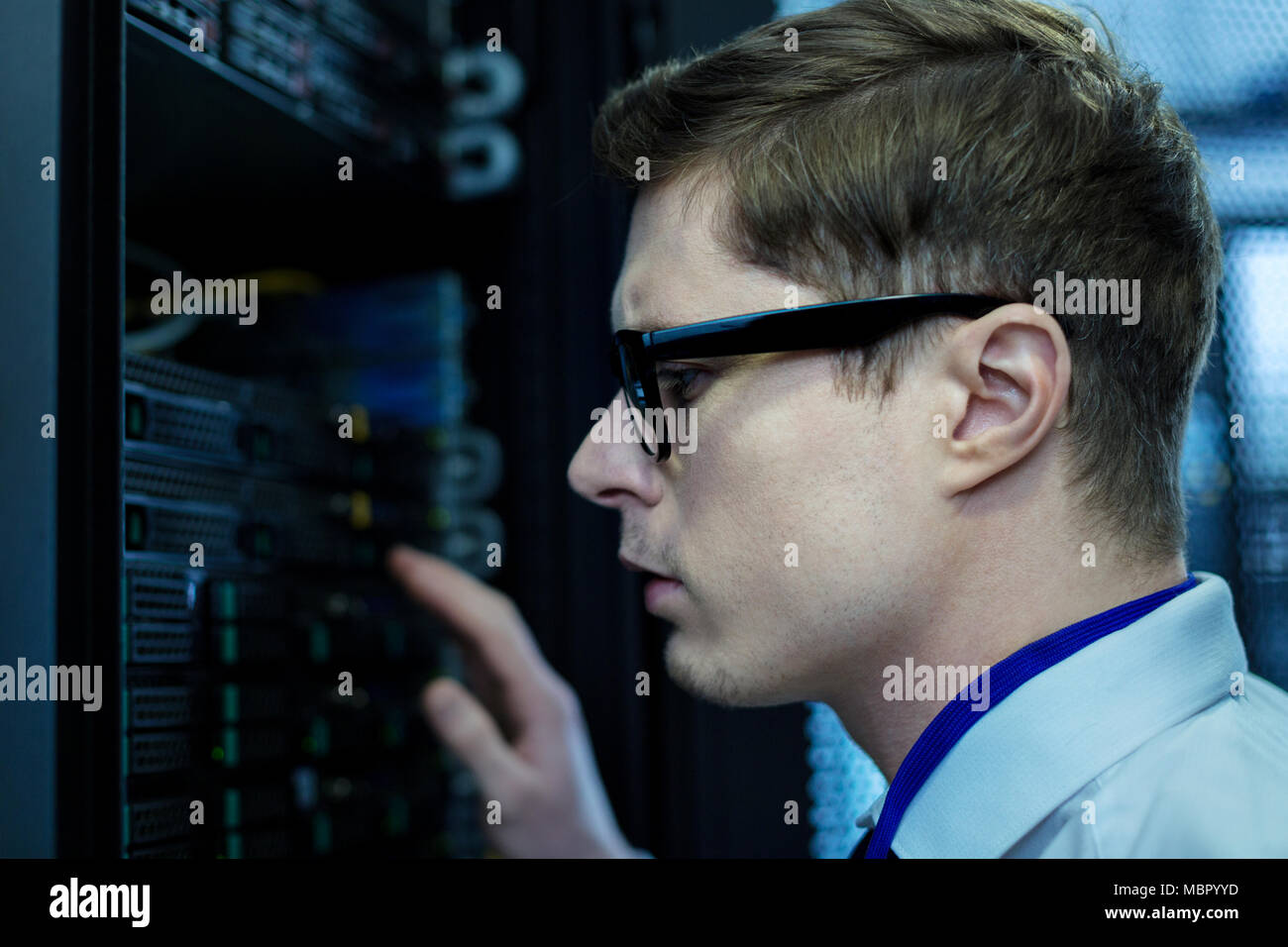 Concentrated operator working in the data centre Stock Photo - Alamy