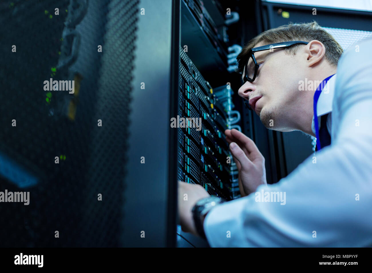 Intelligent operator working in the data centre Stock Photo - Alamy