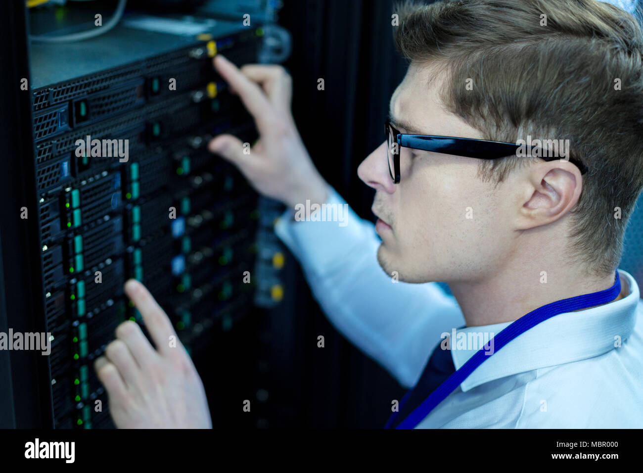 Determined operator pressing right buttons Stock Photo - Alamy