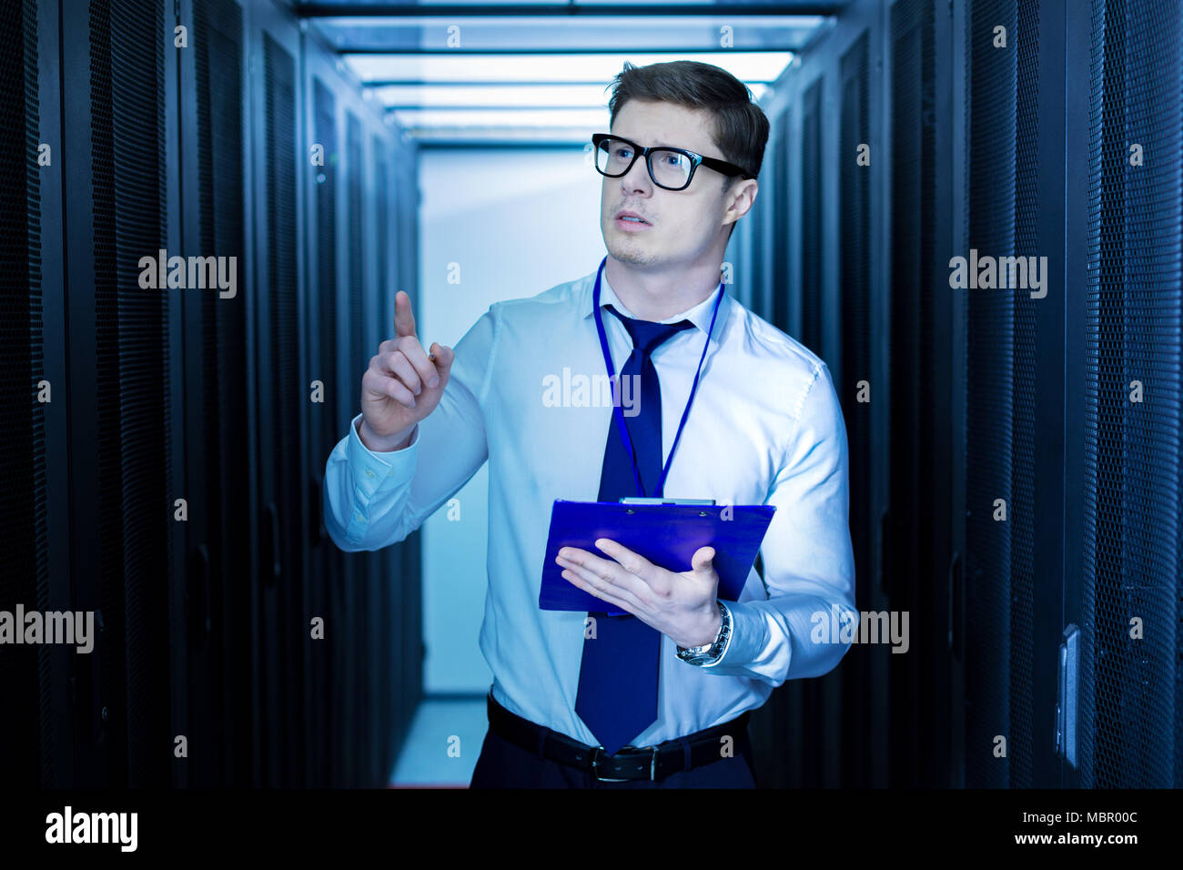 Serious operator pointing a finger Stock Photo - Alamy