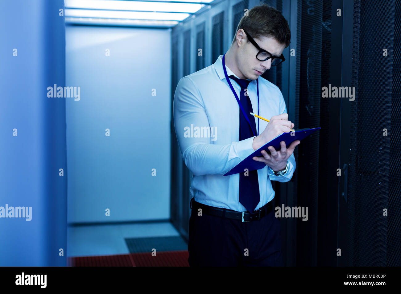 Serious operator taking important notes Stock Photo - Alamy