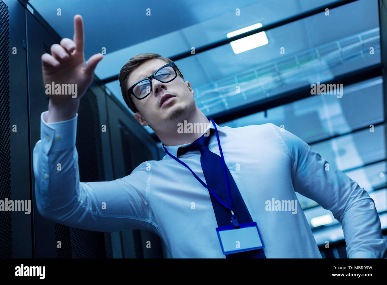Thoughtful employee pointing with his finer Stock Photo - Alamy
