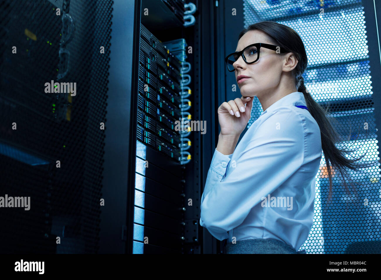 Professional young woman working in a data center Stock Photo - Alamy