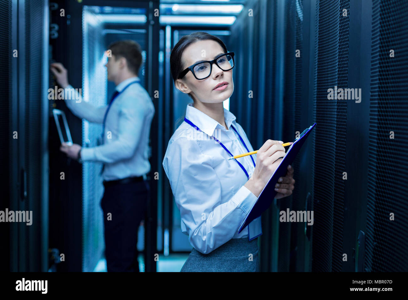 Serious colleagues working in the data center Stock Photo - Alamy