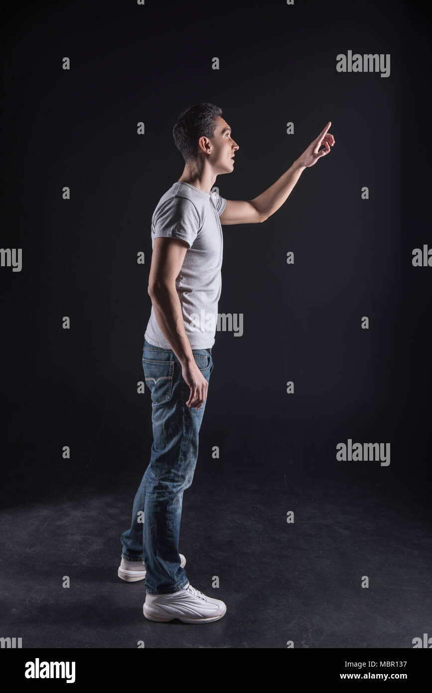 Serious handsome man holding his hand up Stock Photo - Alamy
