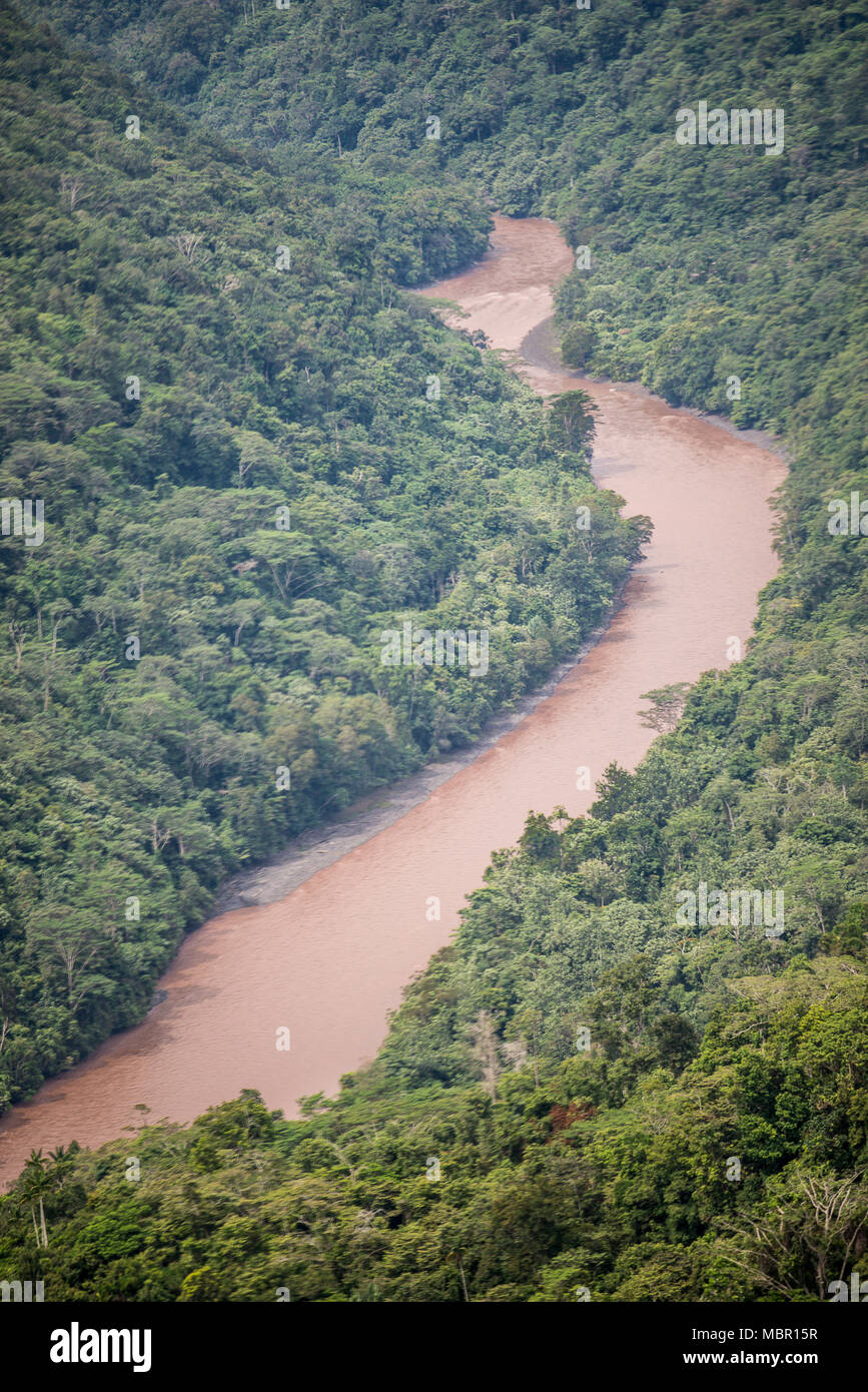 Aerial view of a river with pink waters caused by gold mining pollution ...