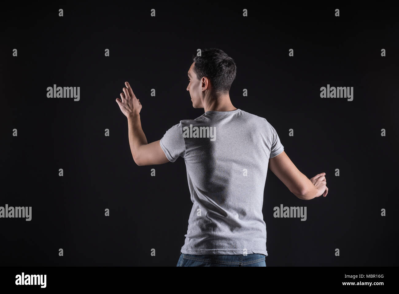 Confident nice man looking at his hand Stock Photo - Alamy