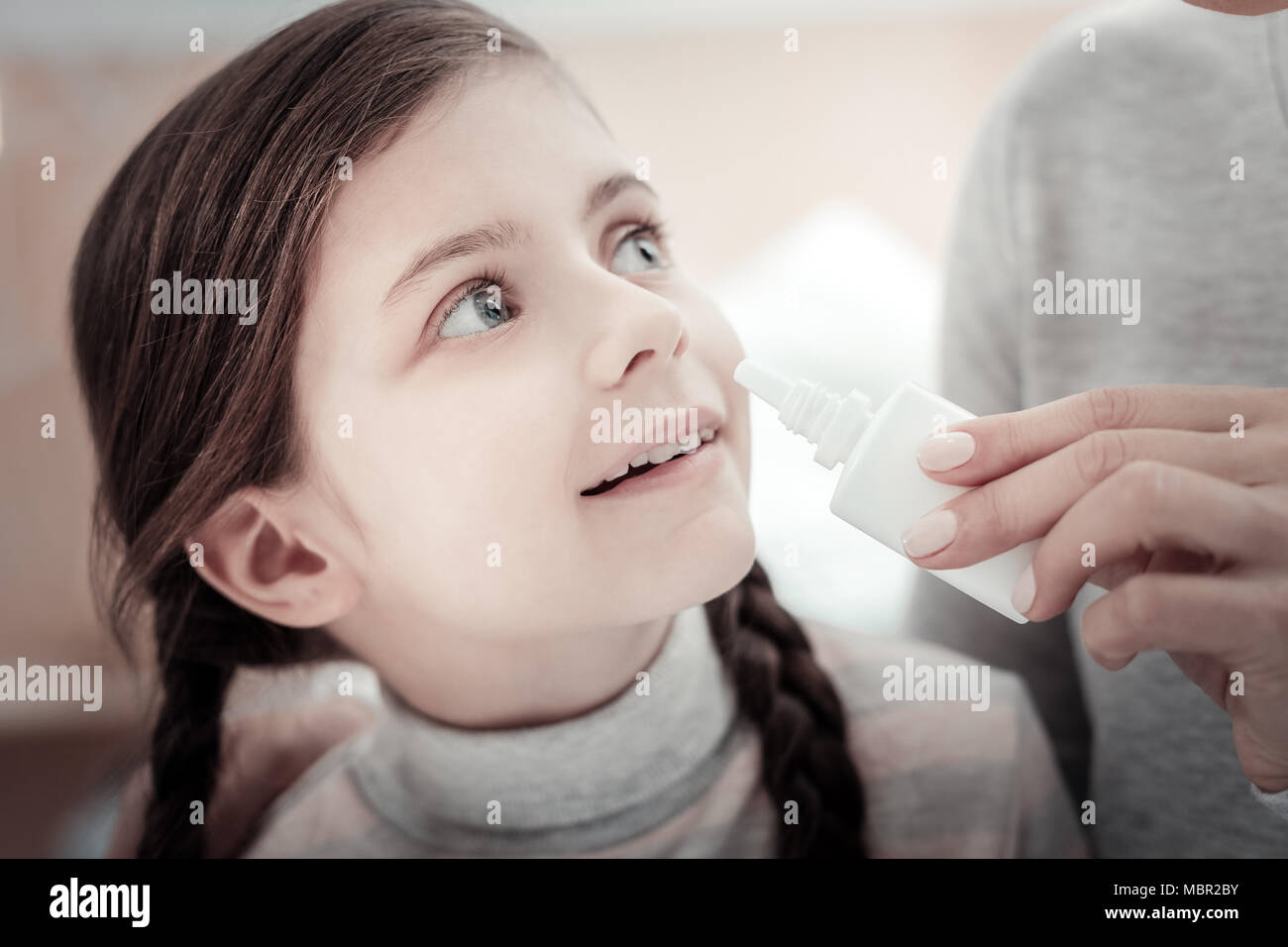 Pleasant sick girl smiling and looking up Stock Photo - Alamy