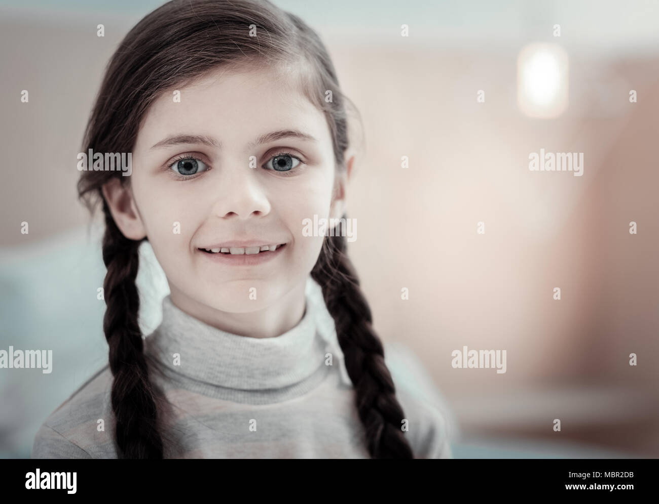 Cute joyful girl feeling good herself and smiling Stock Photo - Alamy