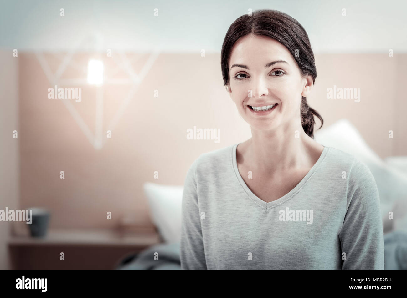 Funny joyful woman sitting and smiling Stock Photo - Alamy