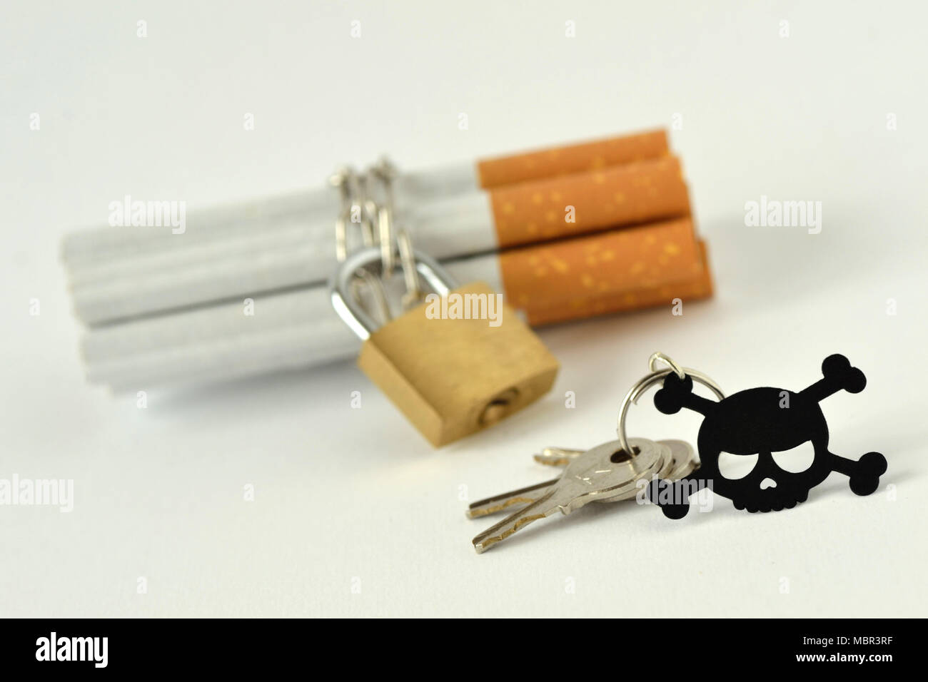 Cigarettes with chain and padlock and key with black skull on white ...