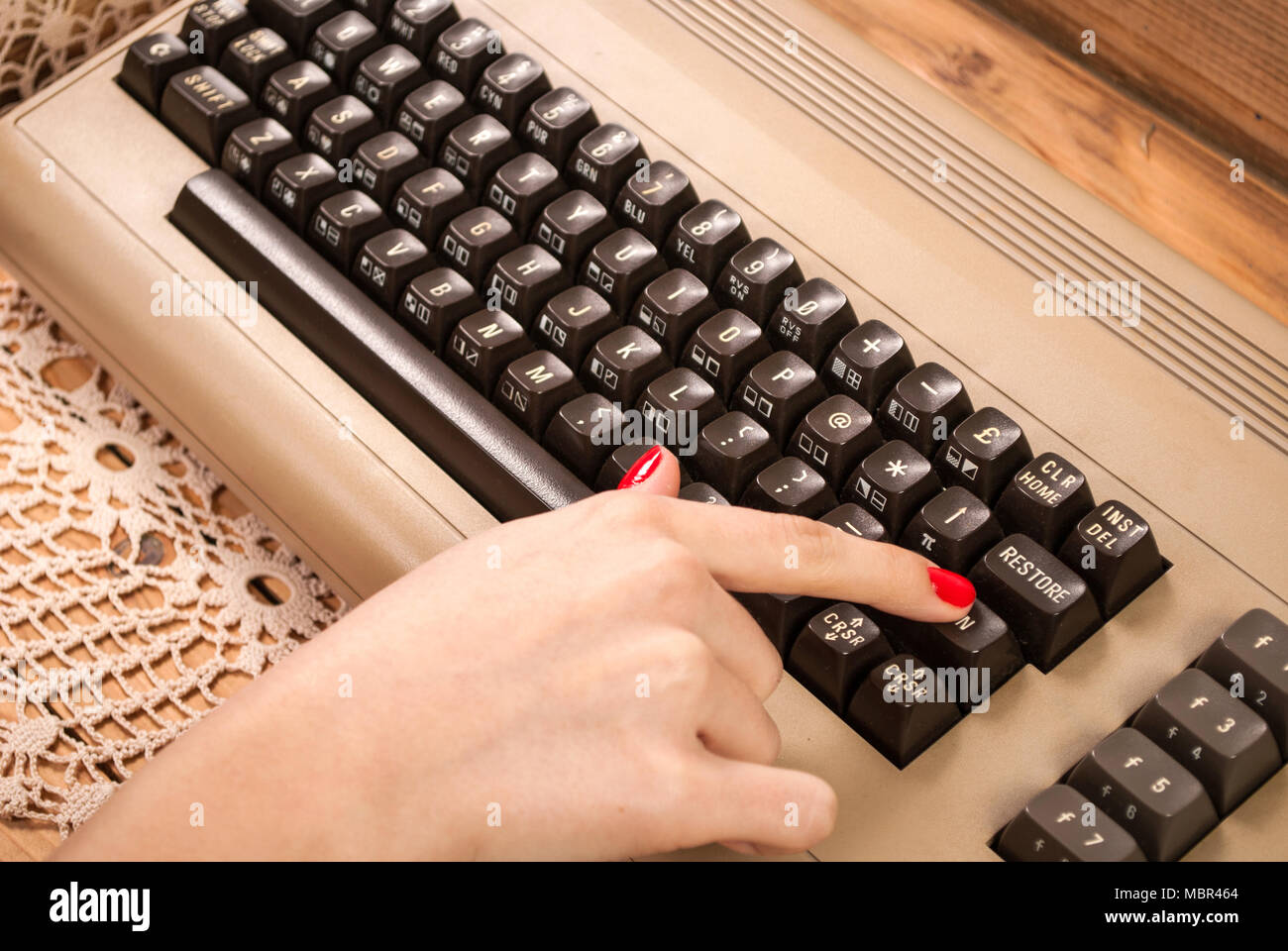 Woman finger press button on old computer keyboard Stock Photo - Alamy
