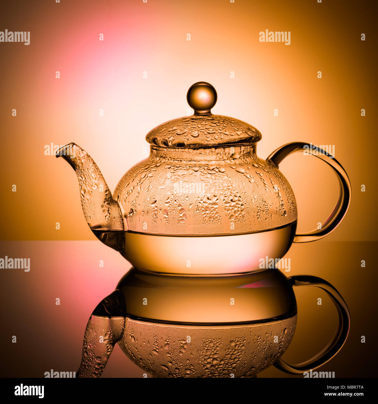 Glass teapot with boiling water and drops of condensation on glass ...