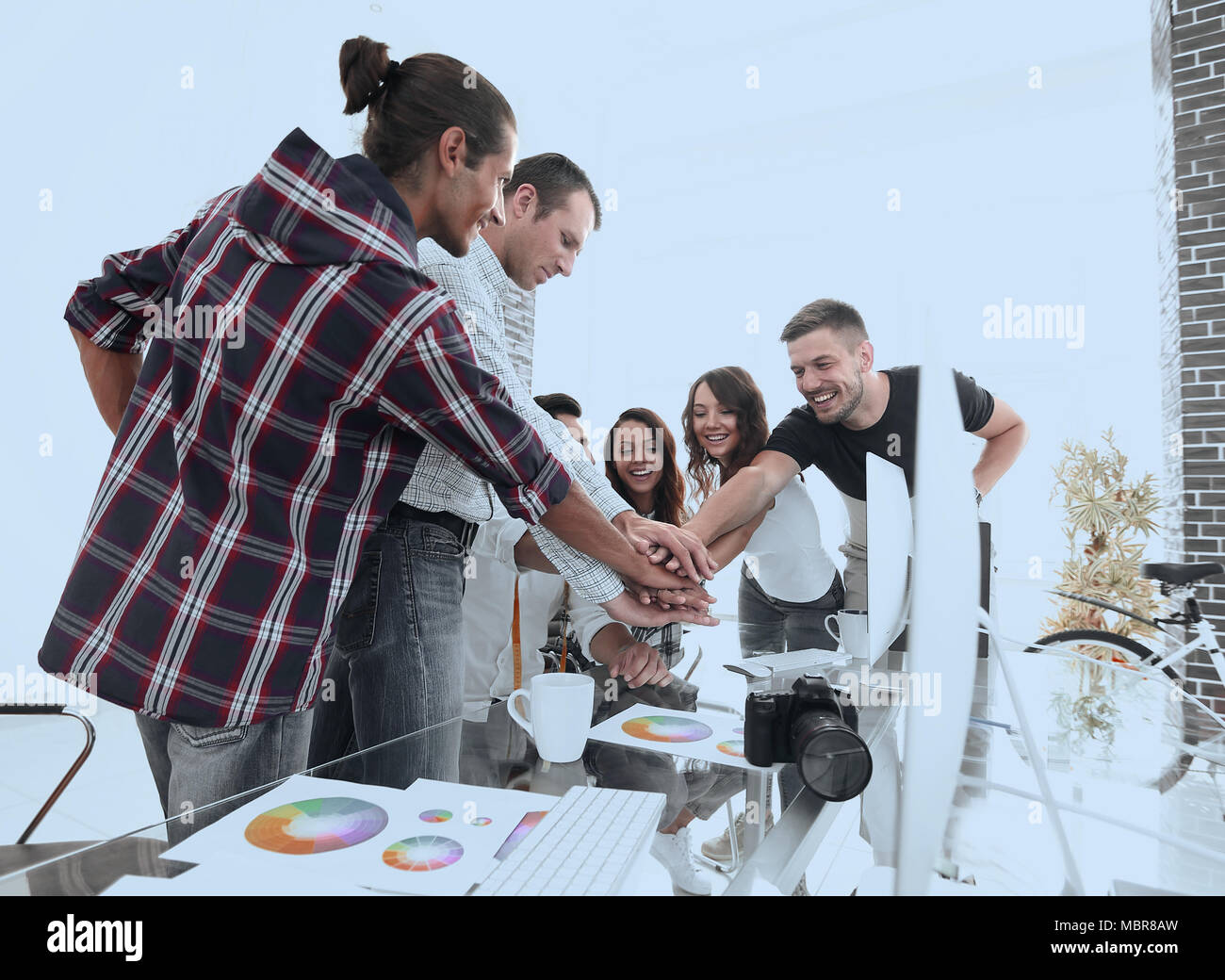 team of designers shows their success Stock Photo - Alamy