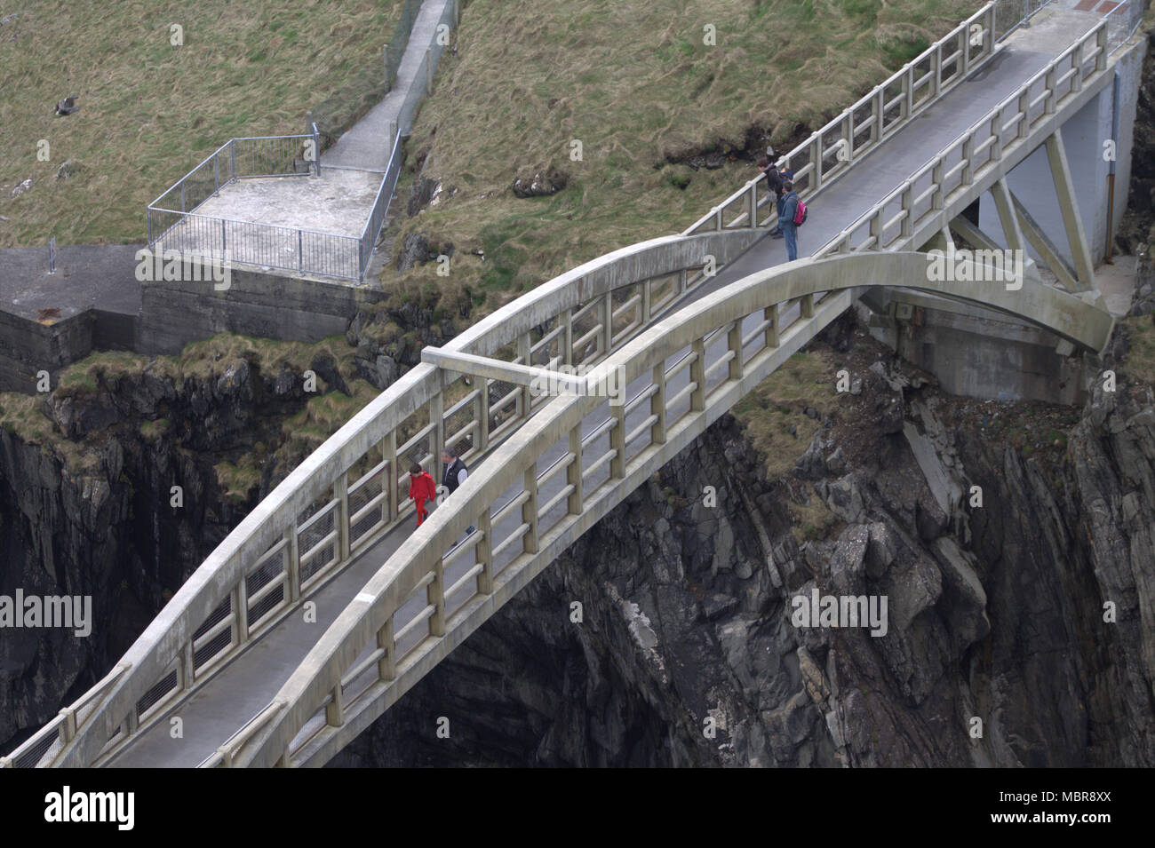 tourists and photographers crossing the mizen head gorge on the ...