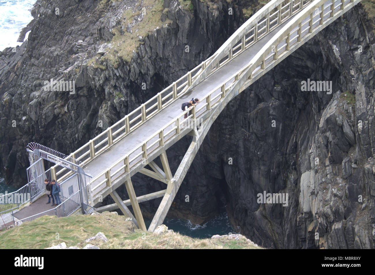tourists and photographers crossing the mizen head gorge on the ...