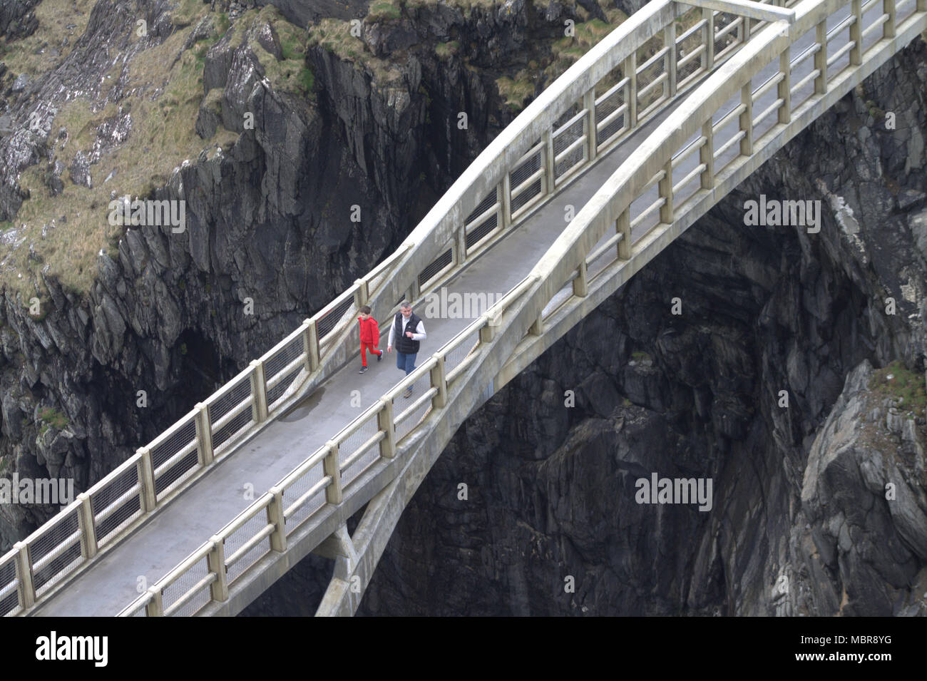tourists and photographers crossing the mizen head gorge on the ...