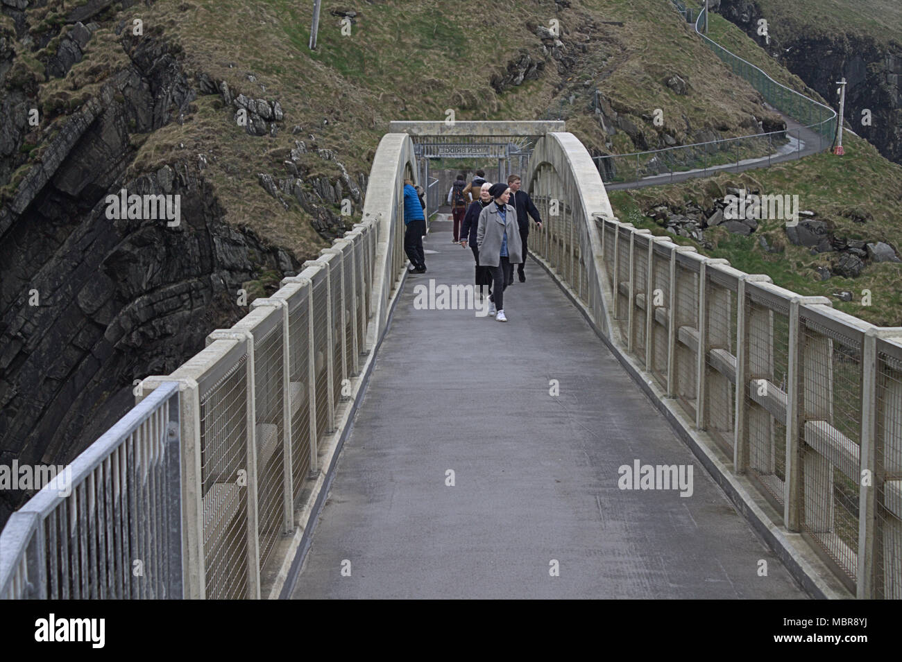 tourists and photographers crossing the mizen head gorge on the ...