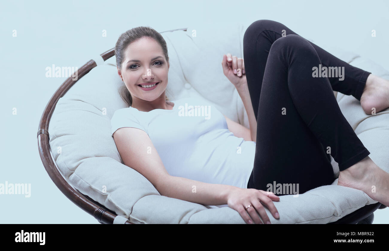 tired woman resting in an easy chair made of rattan Stock Photo - Alamy