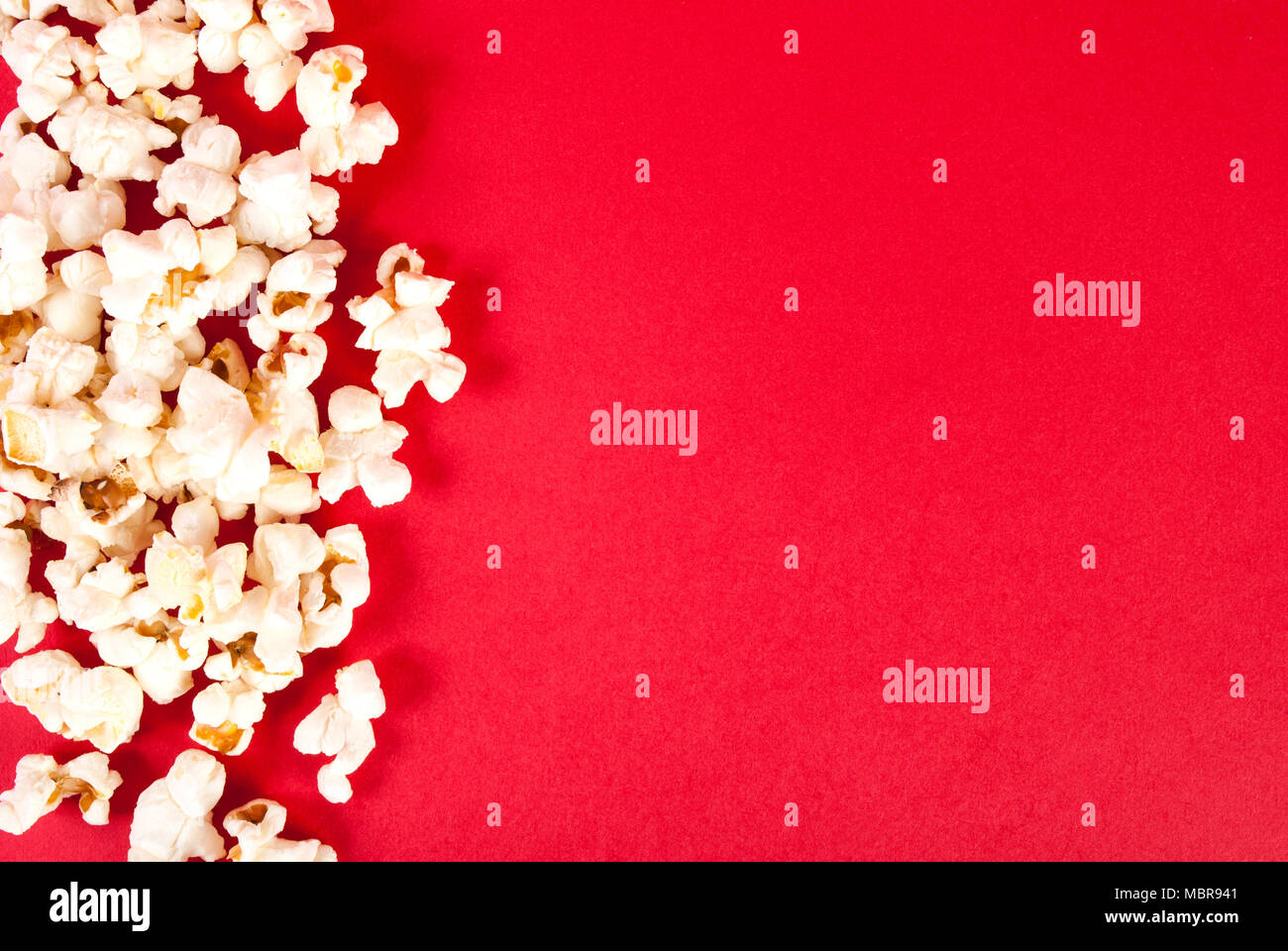 Popcorn on red background with empty space, top view Stock Photo - Alamy