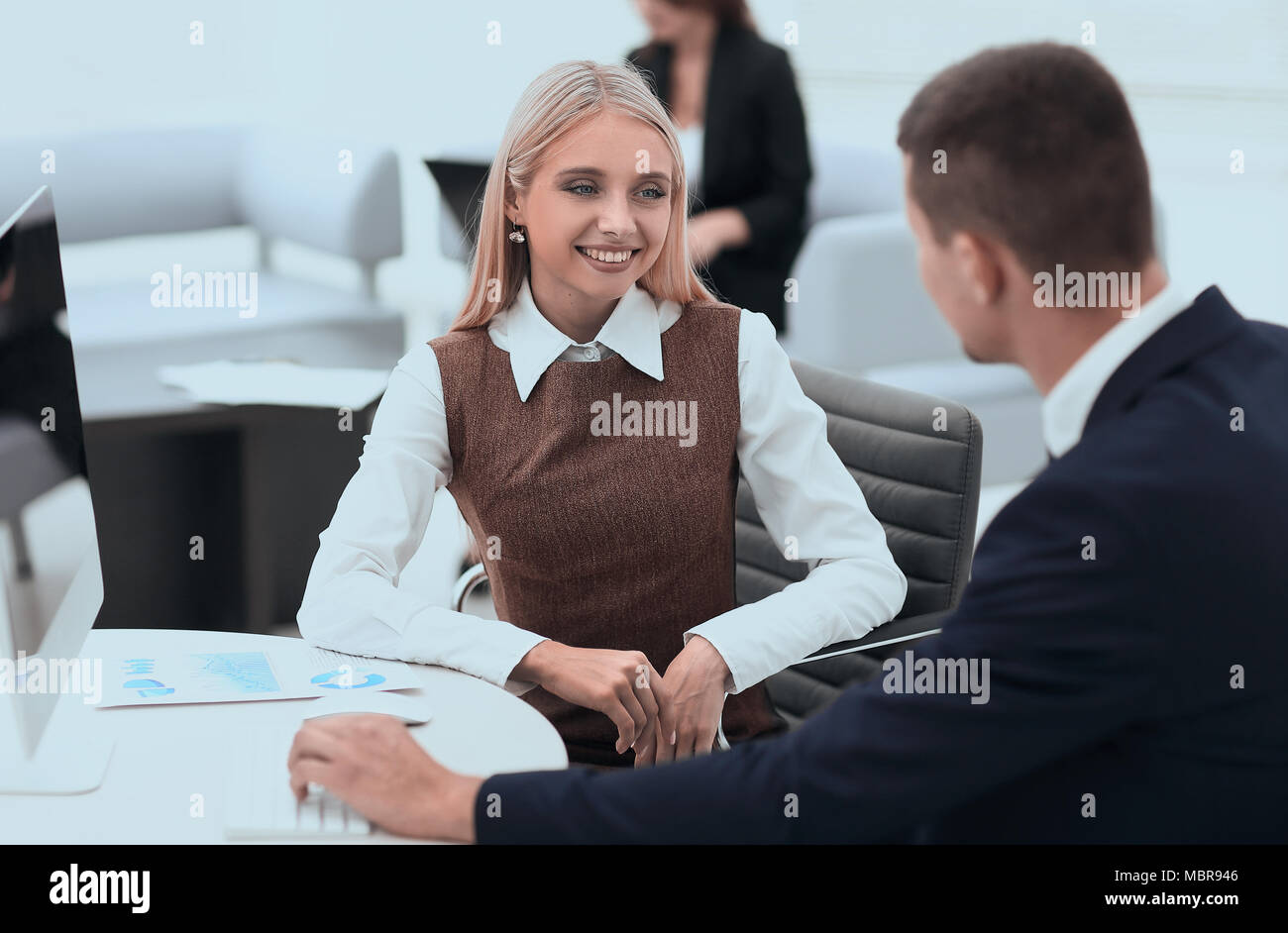 Manager talking with a colleague at the workplace Stock Photo - Alamy